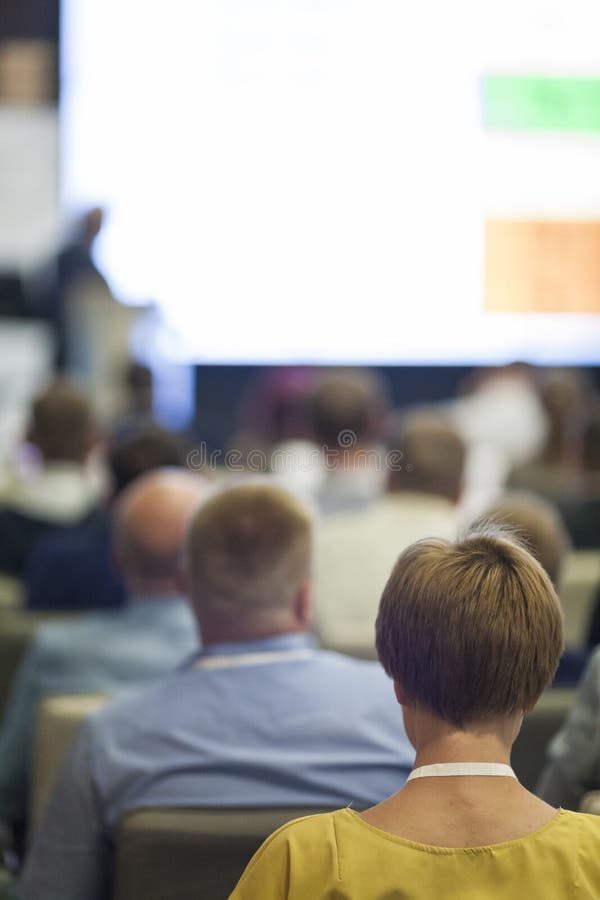 People at the Conference Watching Presentation on Screen in Front ...