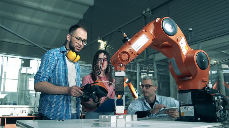 People Control Robotic Arm with Tablets. Innovation, Hi-tech Education ...