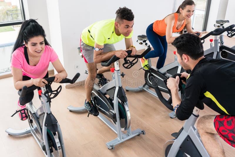 People cycling in gym stock image. Image of cycling - 148812539
