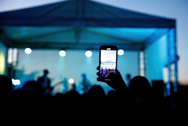 People on the Dance Floor are Shooting a Concert on a Mobile Phone ...