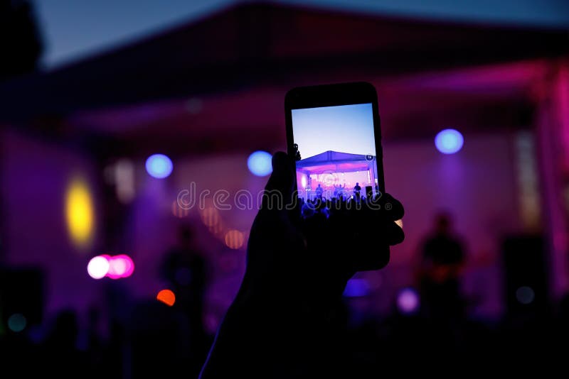 People on the Dance Floor are Shooting a Concert on a Mobile Phone ...