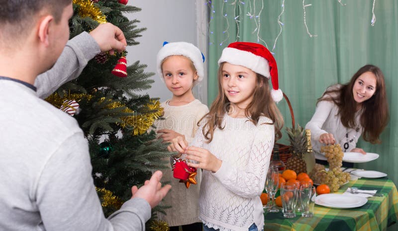 People Decorating Christmas Tree Stock Photo - Image of interior ...
