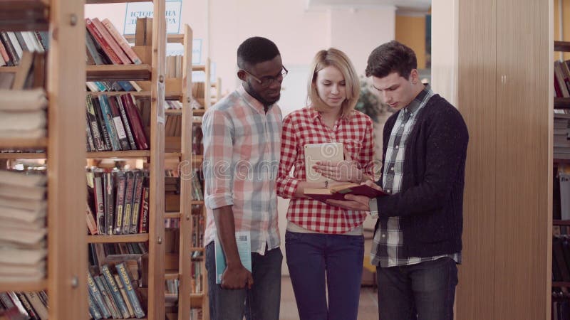 People Discussing Books between Stacks Stock Photo - Image of indoors ... People Discussing Books between Stacks Stock Photo - Image of indoors ...