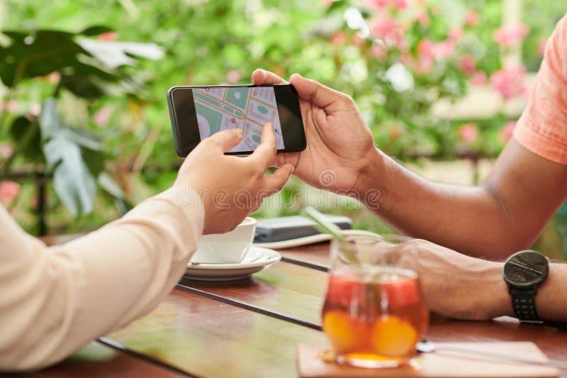 People Discussing Map on Smartphone Stock Photo - Image of hands ...