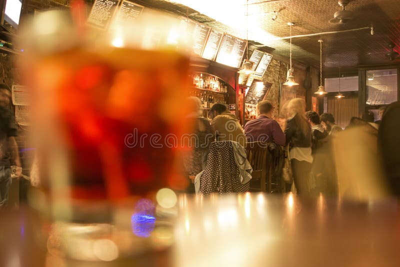 People at the Dive Bar with a Manhattan Cocktail in the Foreground ...