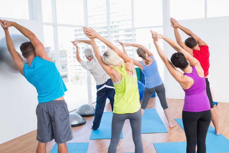 People Doing Stretching Exercise in Yoga Class Stock Image - Image of ...