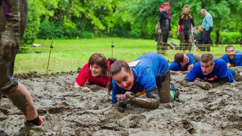 People Crawling through Mud As Part of Obstacle Course Stock Footage ...