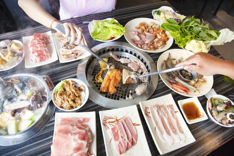 People Eating Barbecue Beef in Restaurant Stock Image - Image of dining ...