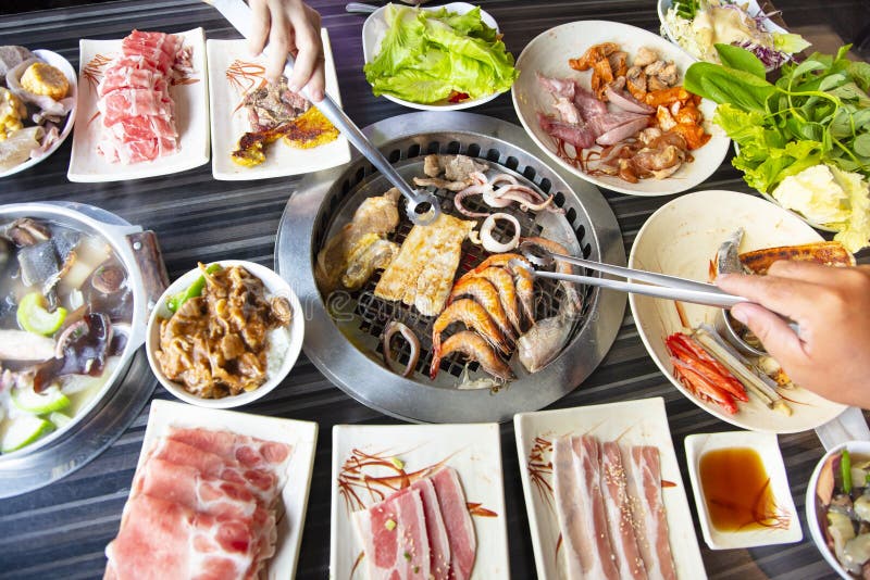 People Eating Barbecue Beef in Restaurant Stock Photo - Image of ...