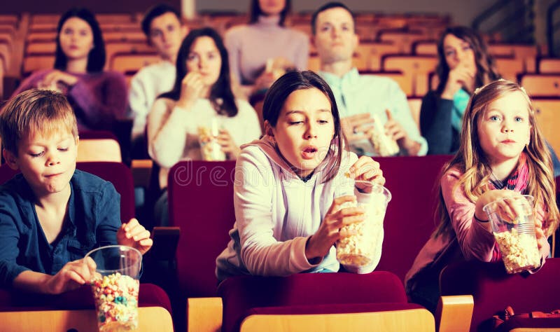 People Eating Popcorn in Cinema Stock Photo - Image of intently ...