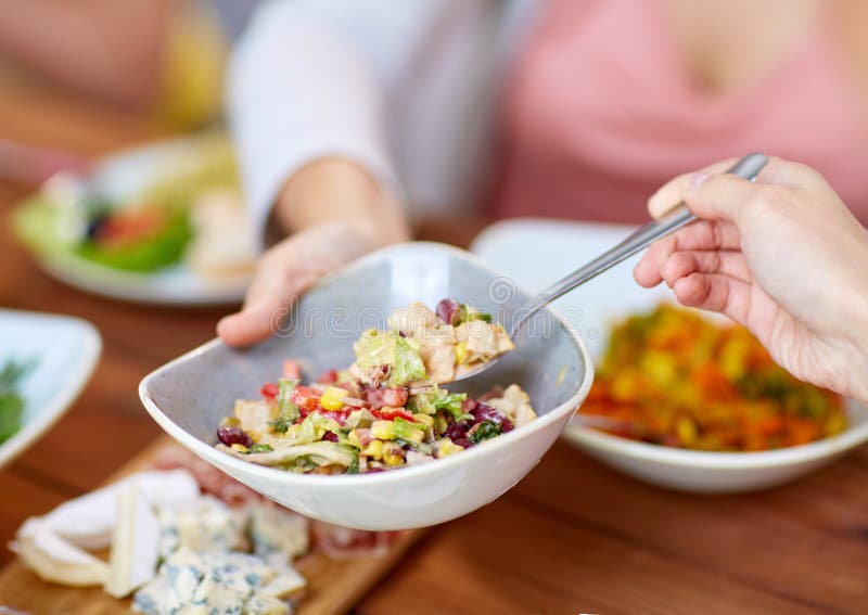 People Eating Salad at Table with Food Stock Photo - Image of sharing ...