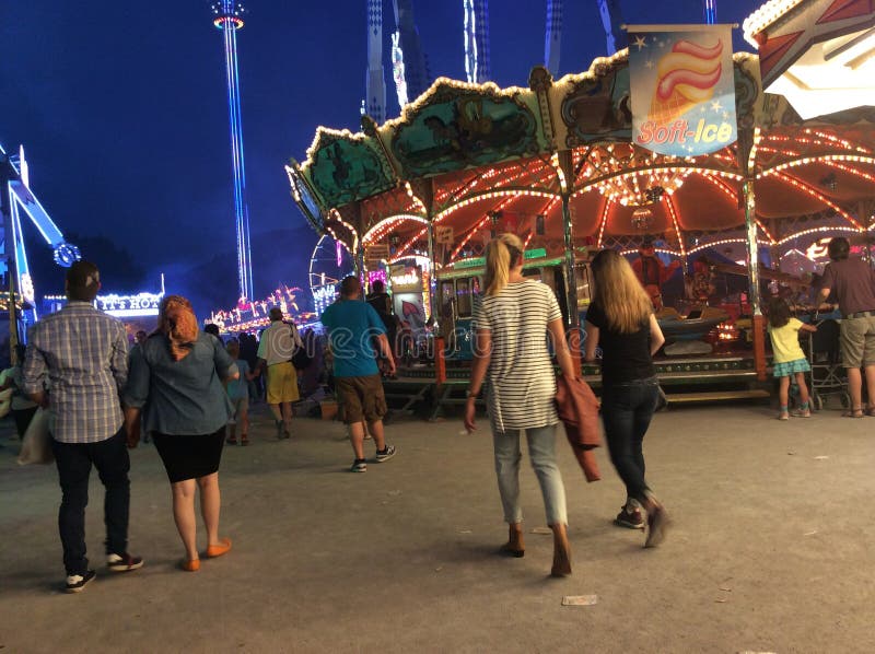 People at a Fair Watching Others on a Fun Ride, Waving Editorial Stock ...