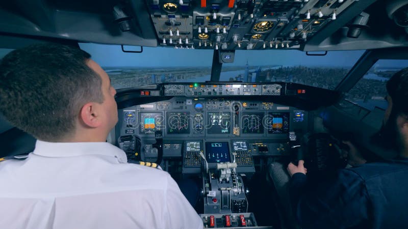 Male Pilots Sit in a Cockpit of a Flight Simulator, Close Up. Stock ...