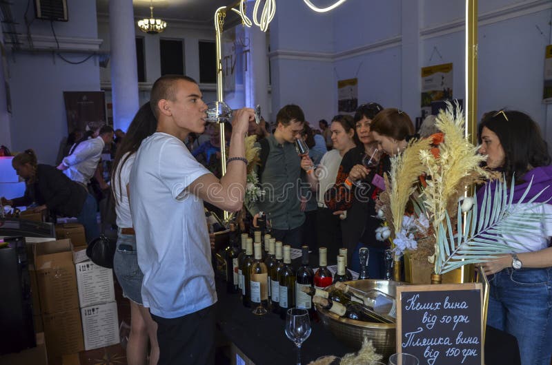 People are Gathered Around a Bar Area and Sampling Various Wines ...