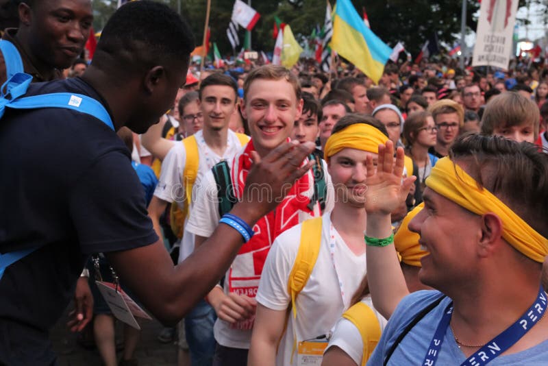 People Give Five a Crowd of People with Flags in the Background ...