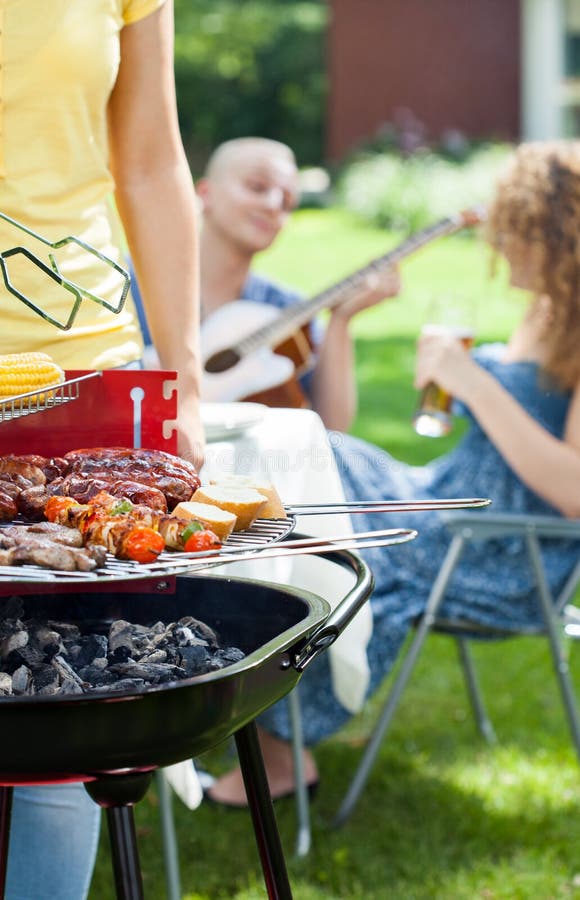 People grilling in garden stock photo. Image of grill - 115225312