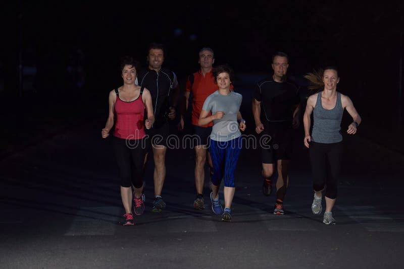 People Group Jogging at Night Stock Photo - Image of adult, nature ...