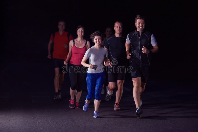People Group Jogging at Night Stock Image - Image of healthy, flare ...