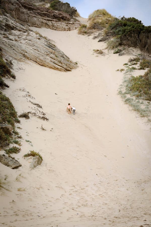 People Having Fun on Sandy Beach with Rocky Cliffs Stock Photo - Image ...