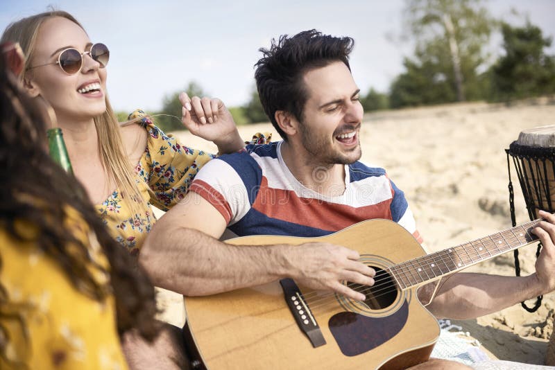 Friends Having Great Fun on the Beach Stock Image - Image of musical ...