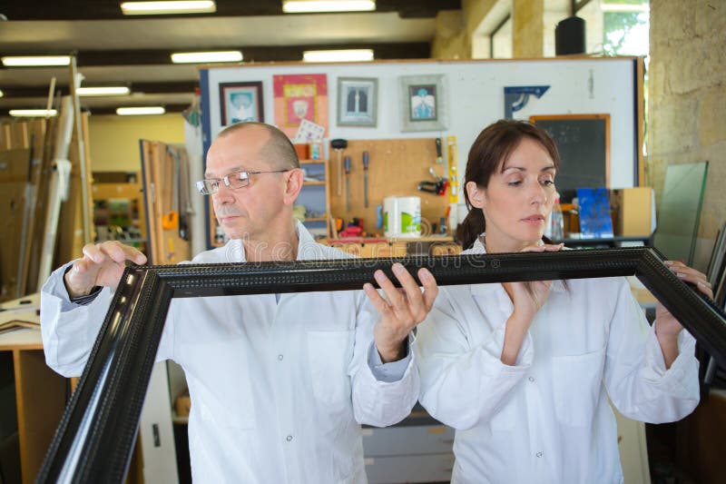 People holding frame stock photo. Image of technician - 281913516