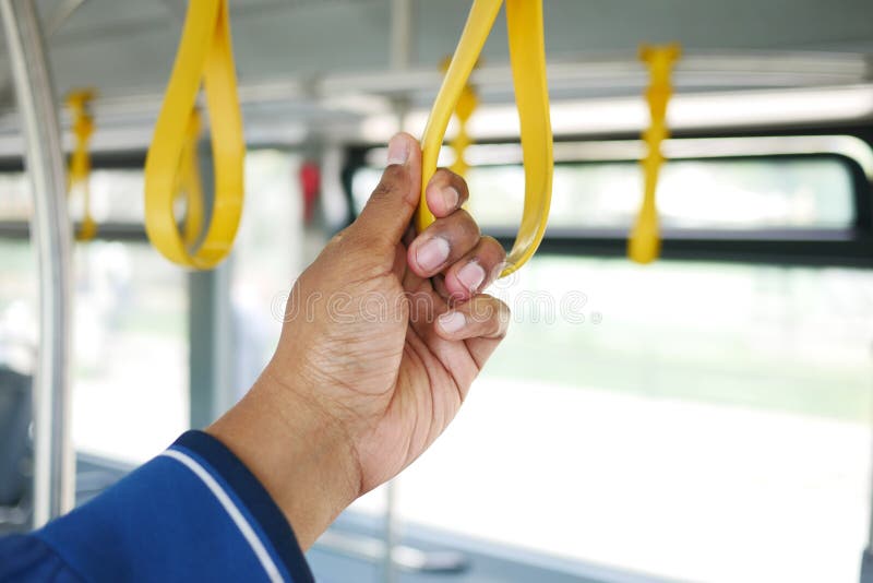 People Holding Onto a Handle on a Bus . Stock Photo - Image of painted ...