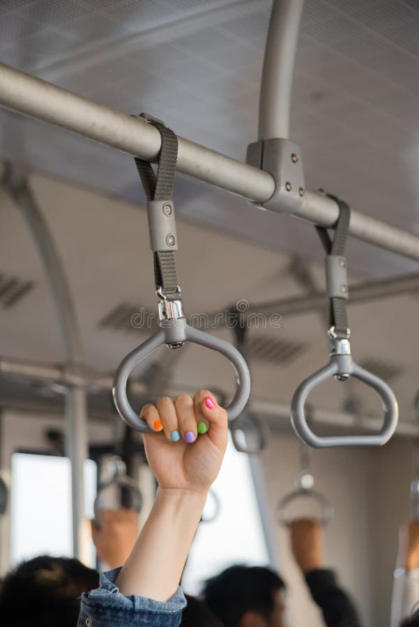 People Holding Onto a Handle on a Train Stock Photo - Image of fingers ...