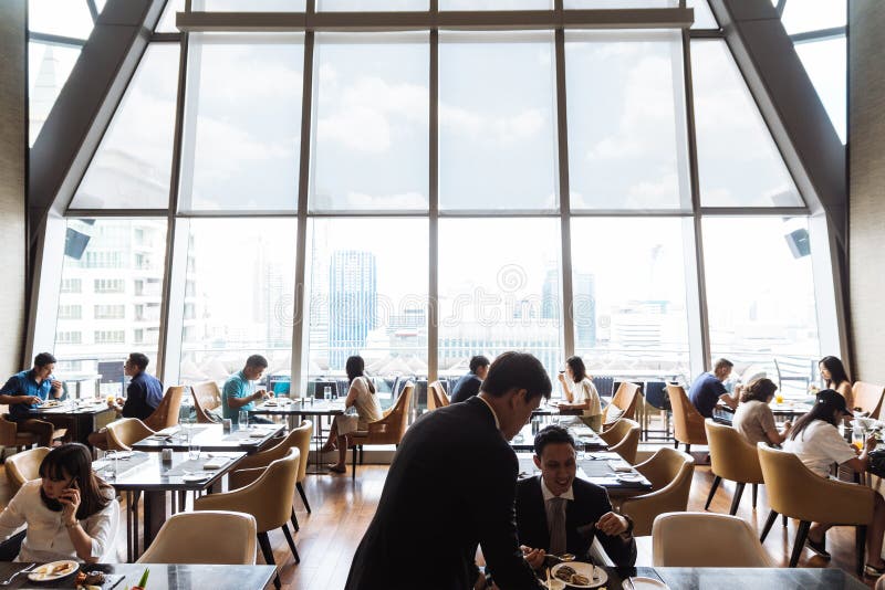 People in Hotel Buffet Restaurant with Cityscape in the Background ...