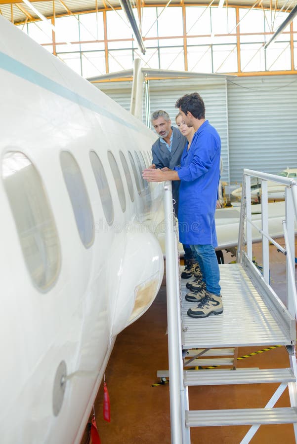 People Inspecting Aircraft Fuselage Stock Image - Image of engineer ...