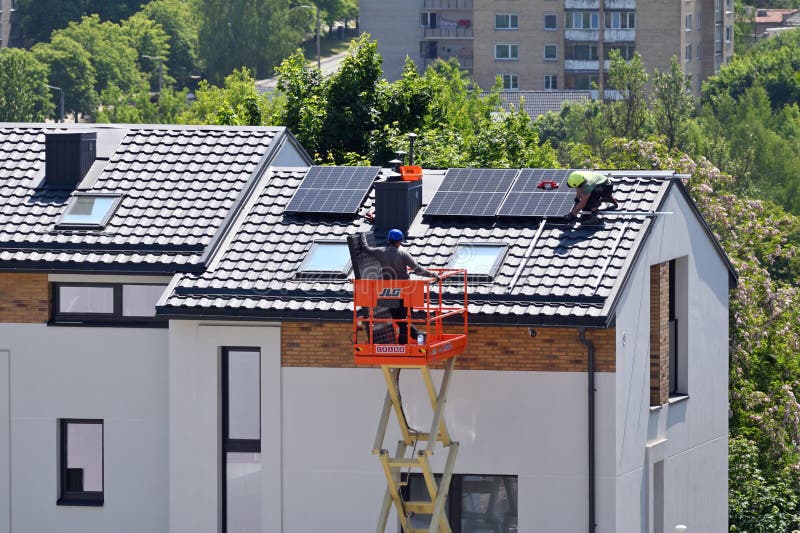 People Installing Solar Panels on the Roof Editorial Stock Photo ...