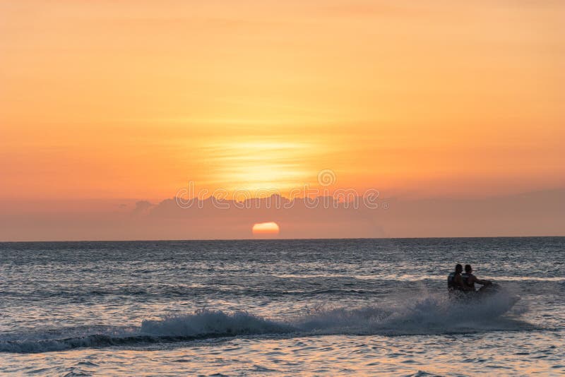 Jet ski in a sunset at sea stock image. Image of marin - 242777081