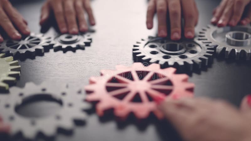 People Joining Cog Wheel on the Black Desk. Stock Footage - Video of ...