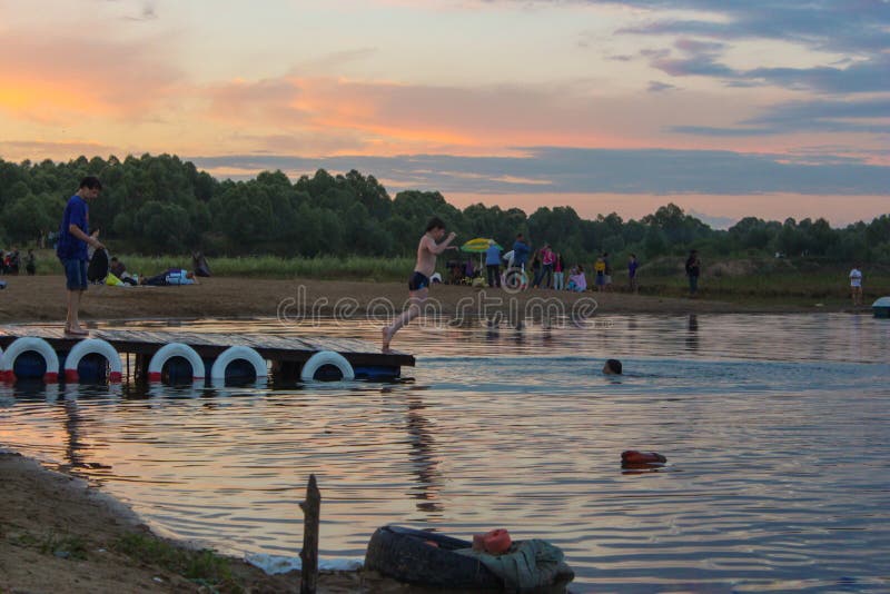 People in the lake shore editorial photo. Image of playing - 135136341