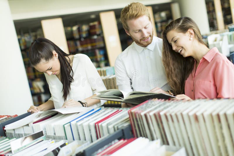 Students in the library stock photo. Image of bookshelf - 58614108