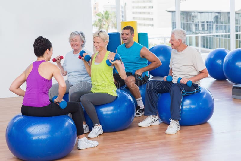 People Lifting Dumbbells in Gym Class Stock Photo - Image of flooring ...