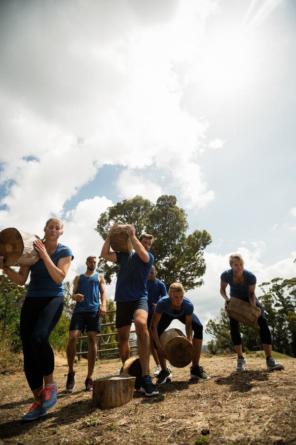 People Lifting Heavy Wooden Logs Obstacle Course Stock Photos - Free ...