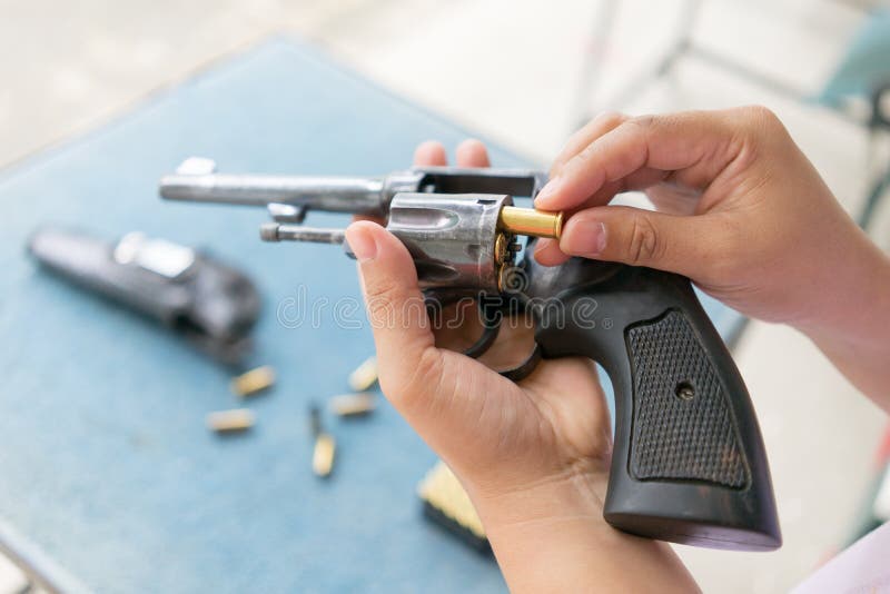 People Load Bullets into Revolver Gun Stock Photo - Image of ammo ...