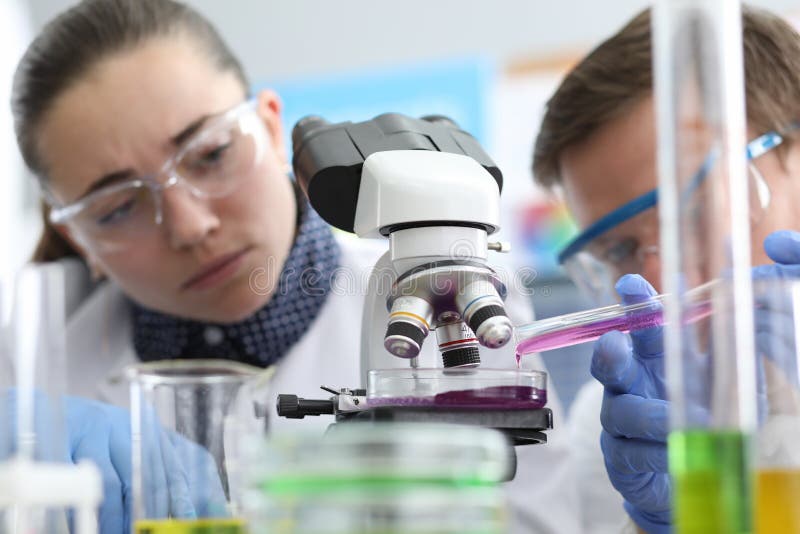 People Look at Reaction Liquid Under Microscope. Stock Image - Image of ...