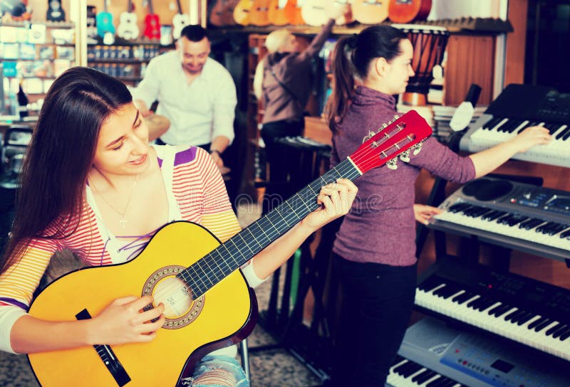 People Looking at Musical Instruments Stock Photo - Image of indoors ...