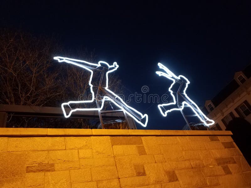 People Made from Light Running and Jumping on the Top of a Building ...