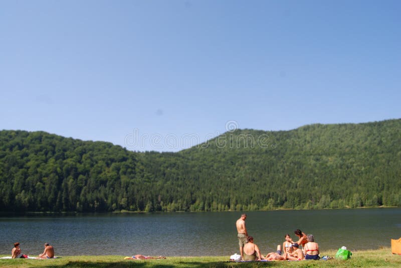 People at a mountain lake editorial stock photo. Image of relax - 51015718