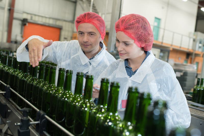 People Overseeing Wine Bottles Go Down Production Line Stock Photo ...
