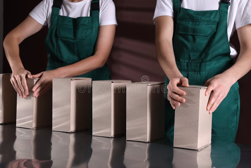 People Packing Cardboard Boxes at Production Line, Closeup Stock Photo ...