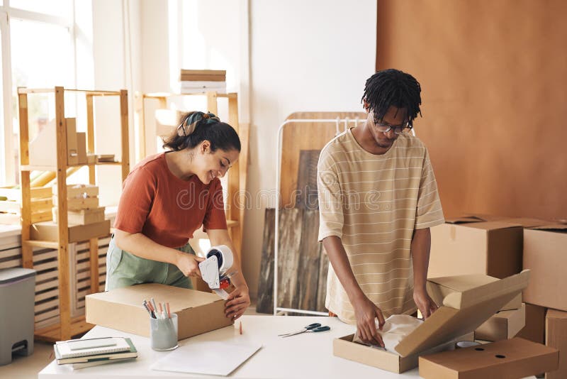 People packing clothes stock image. Image of warehouse - 197593559