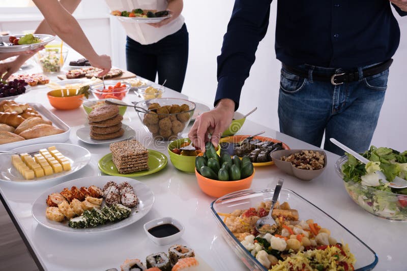 People Picking Food at Party Stock Photo - Image of food, gourmet ...
