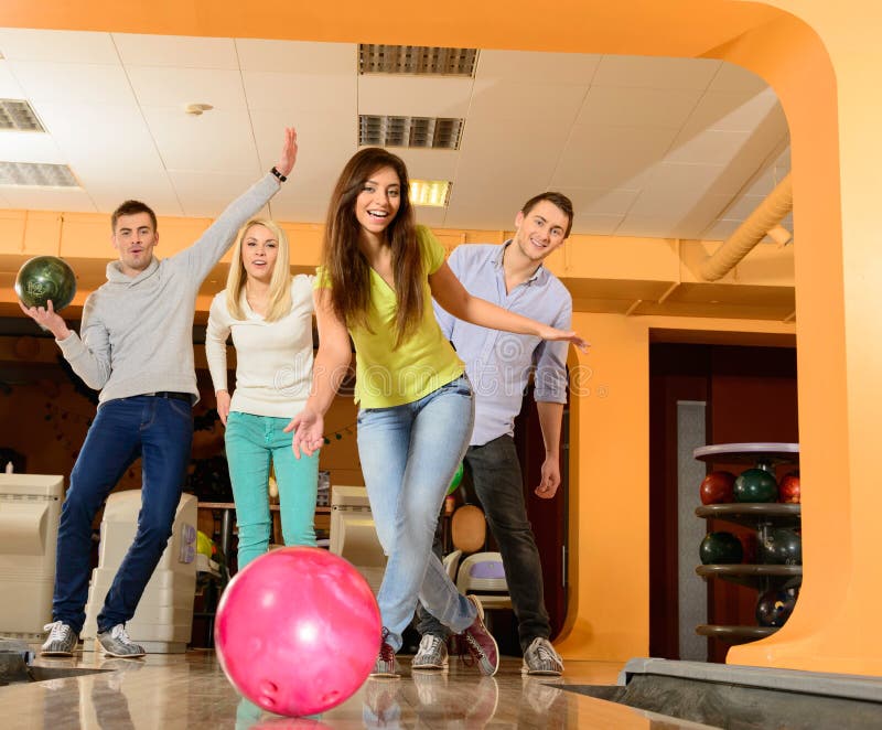 Family in Bowling Alley with Two Friends Smiling Stock Photo - Image of ...
