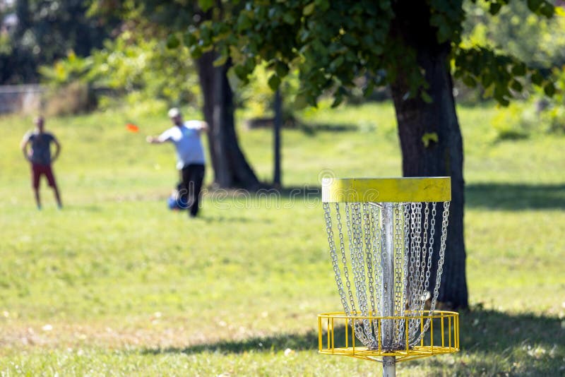 People Playing Flying Disc Golf Sport Game in the Park Stock Photo ...