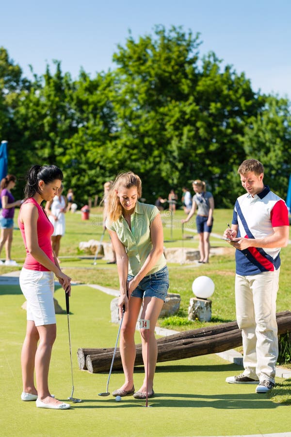 People Playing Miniature Golf Outdoors Stock Photo - Image of game ...
