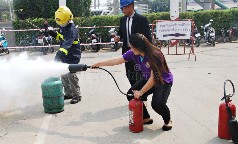 People Practicing a Fire Drill Putting Out a Fire with a Powder Type ...