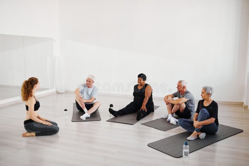 People Practicing Yoga with Coach Stock Image - Image of instructor ...